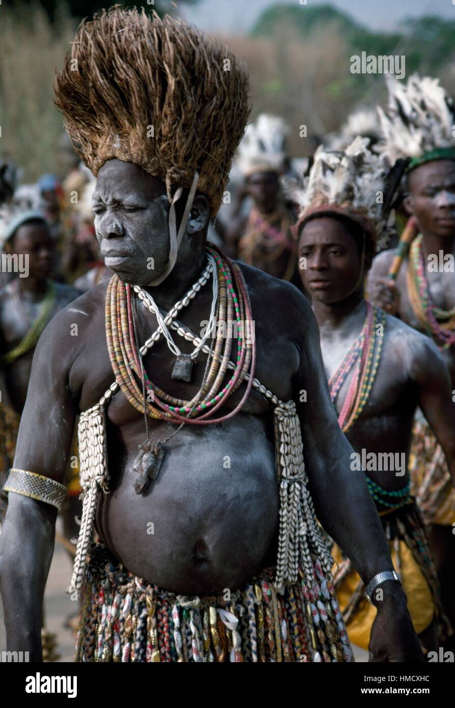 Men wearing traditional costumes and headgear during a festival, Togo ...