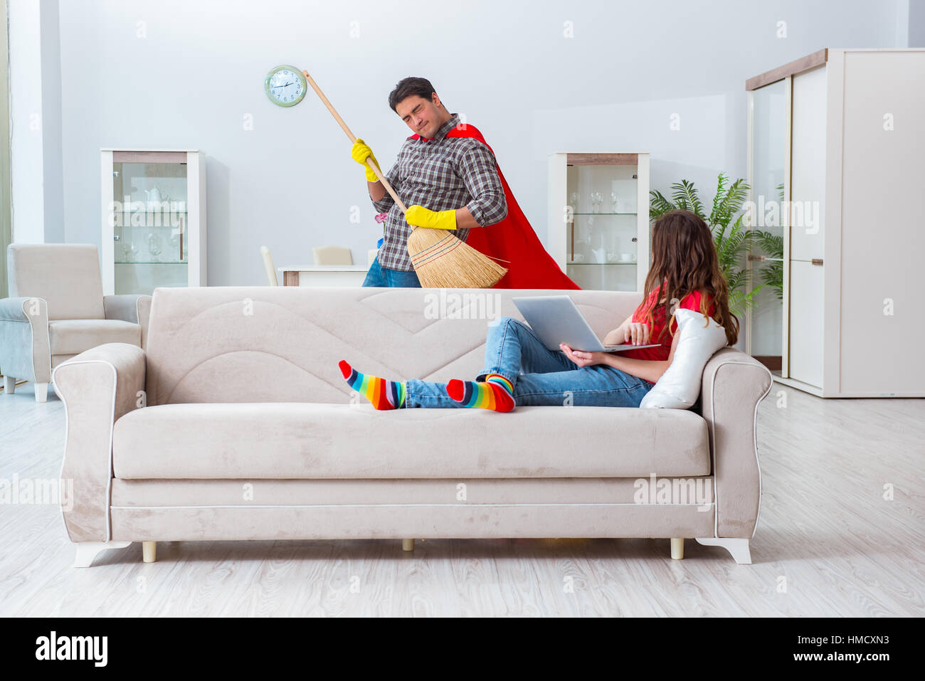 Superhero husband helping his wife at home Stock Photo - Alamy
