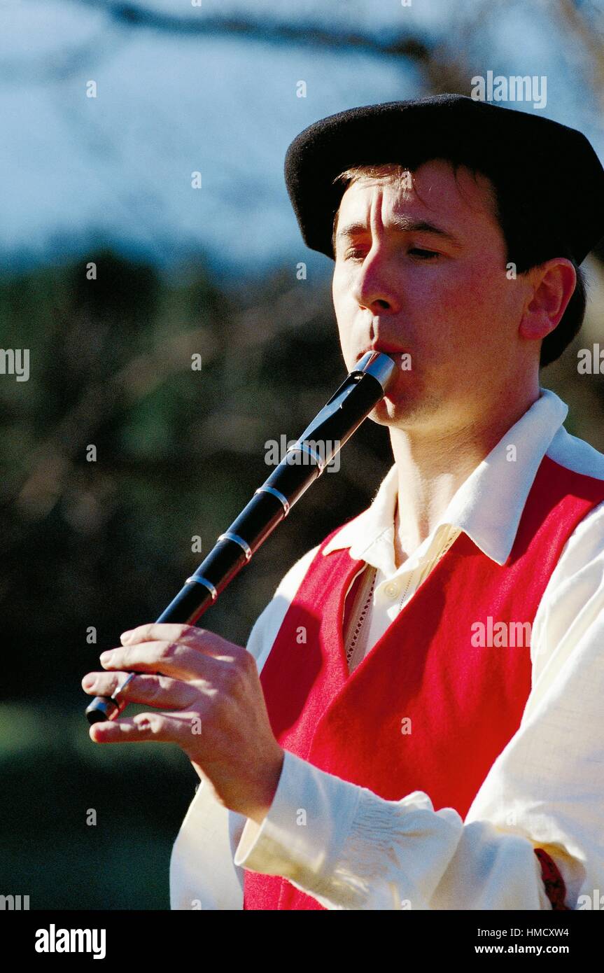 Flute player in traditional Basque clothes near Mount Igueldo, San ...