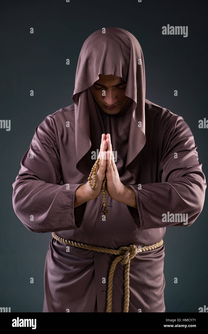 Monk in religious concept on gray background Stock Photo - Alamy