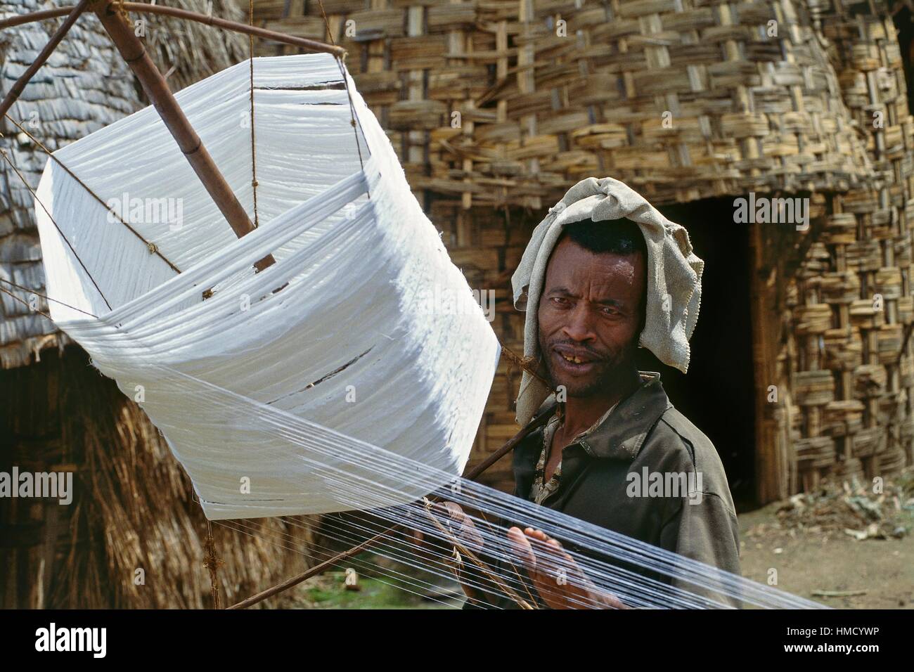Dorze man busy weaving strands of wool, Chencha, Rift Valley, Ethiopia ...