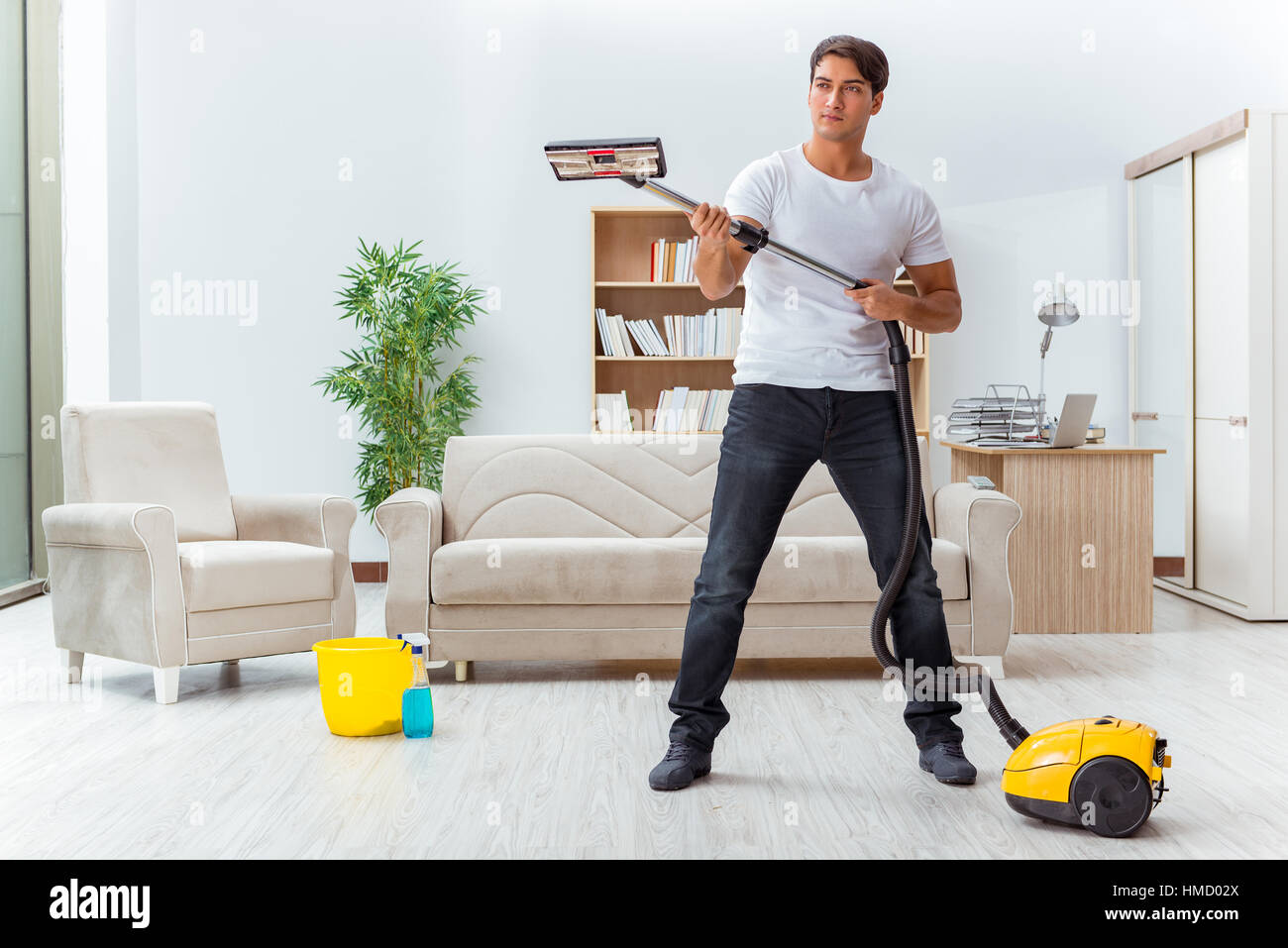 Man husband cleaning the house helping wife Stock Photo - Alamy