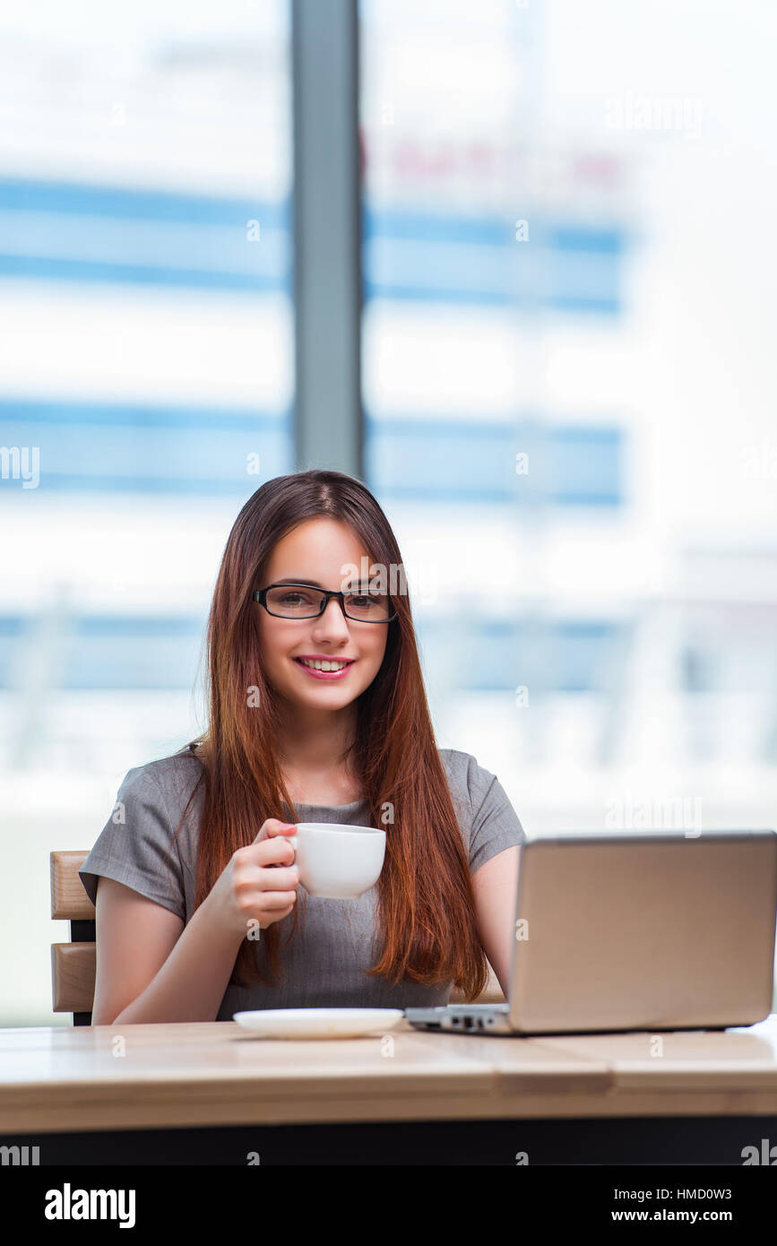 Young businesswoman drinking tea in office Stock Photo - Alamy