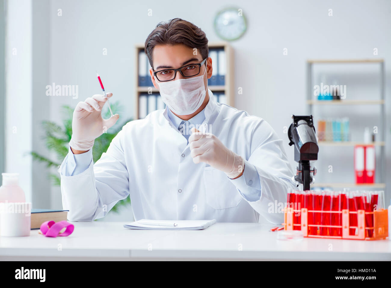 Young doctor working in the lab with microscope Stock Photo - Alamy