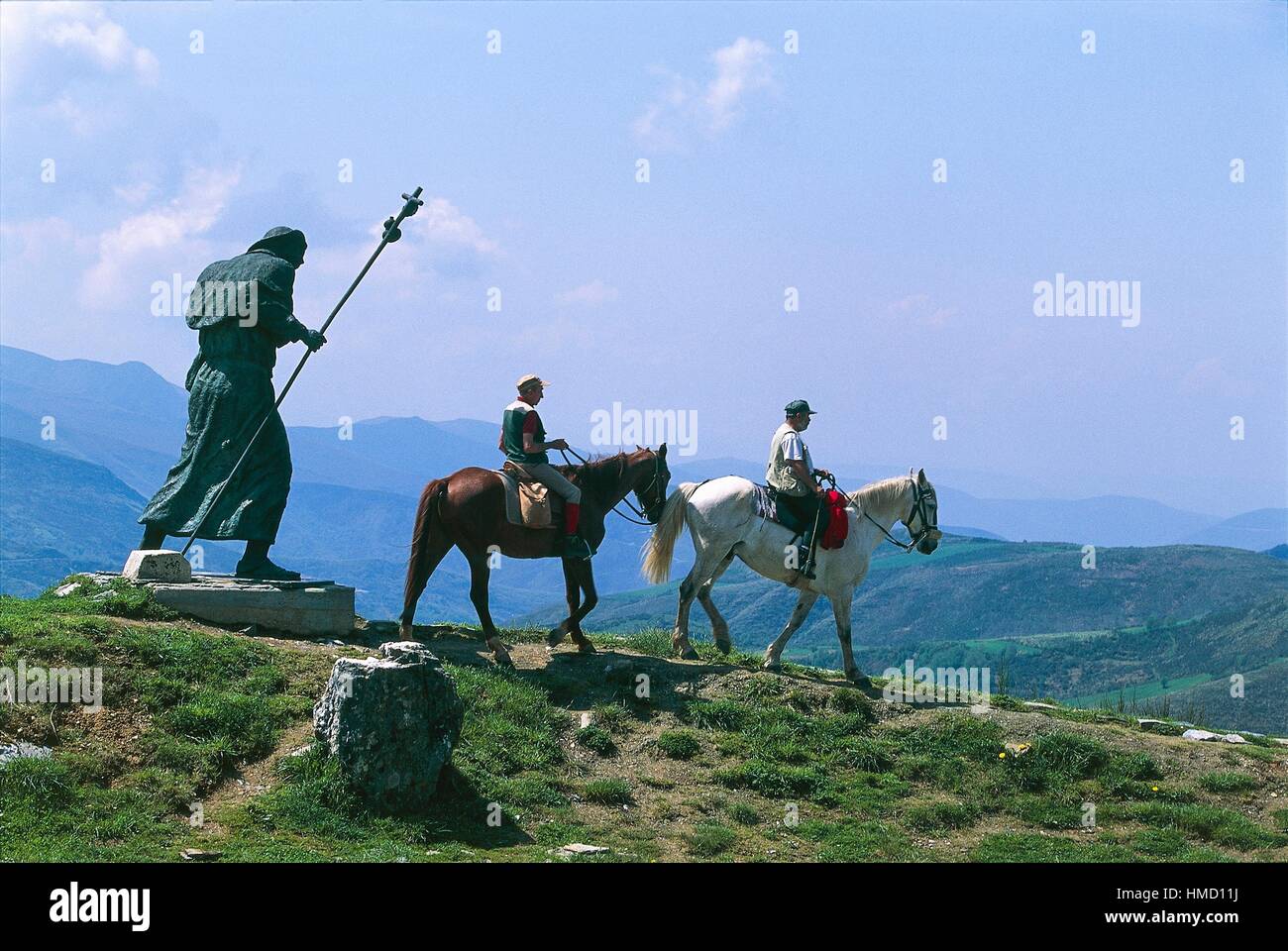 Men on horseback near the bronze pilgrim statue, near Alto de San Roque ...