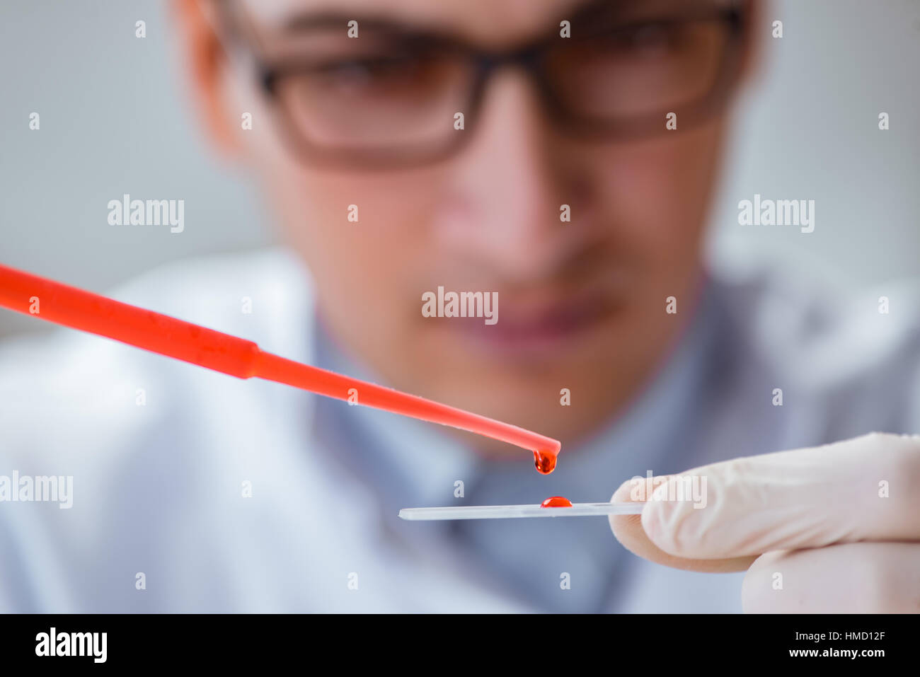 Young doctor doing the blood test Stock Photo - Alamy