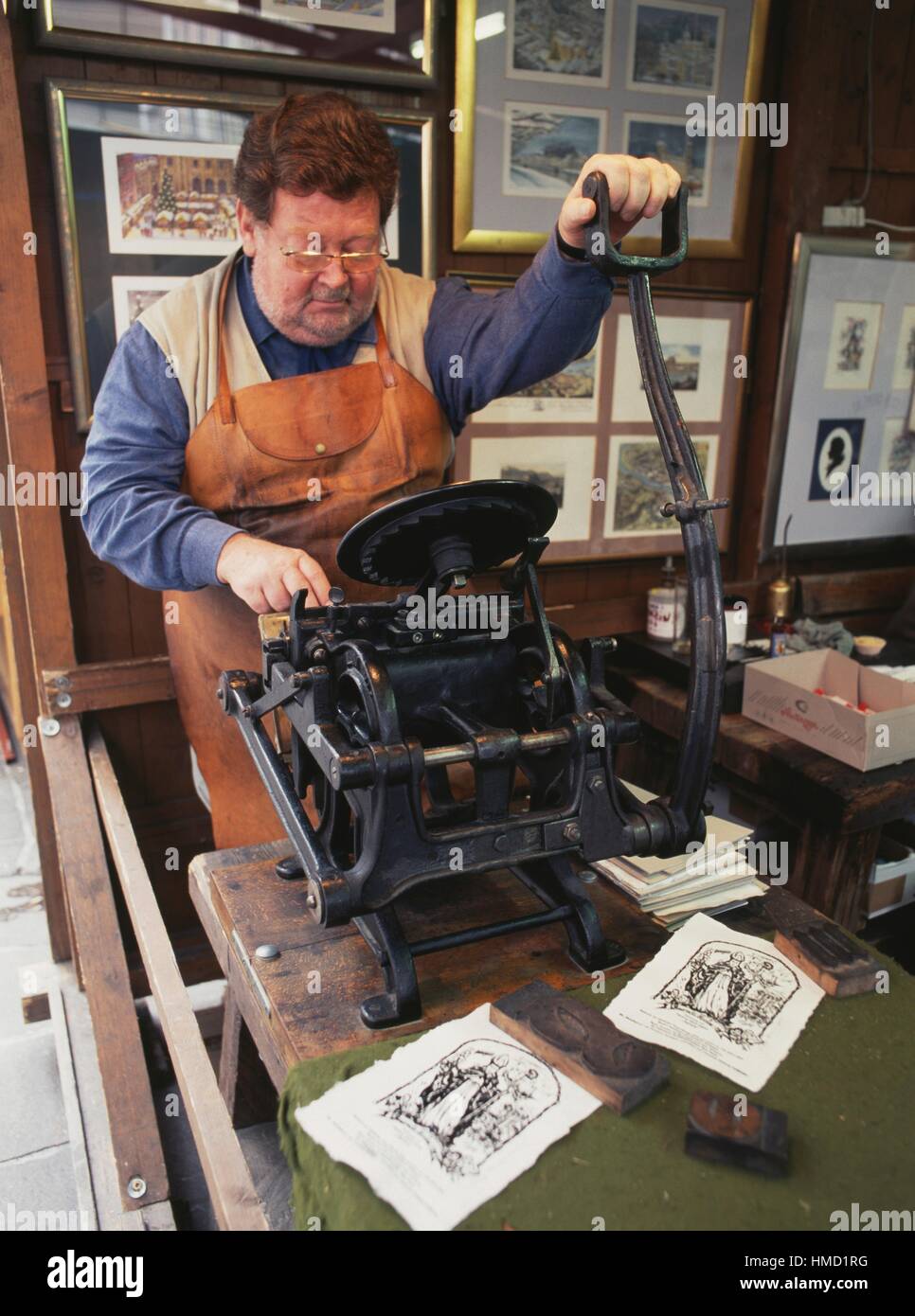 Craftsman working with a foot powered printing press, Salzburg, Austria ...