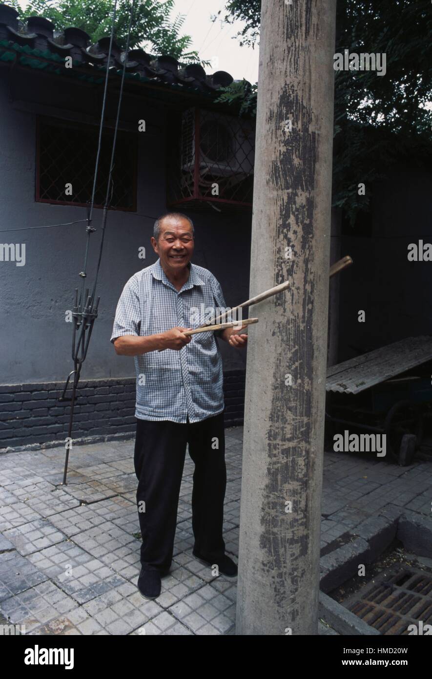 Man holding sticks, Beijing, China Stock Photo - Alamy