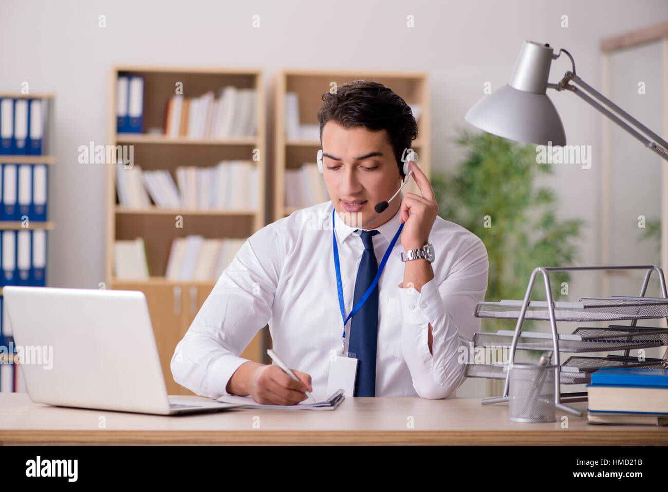 Handsome customer service clerk with headset Stock Photo - Alamy