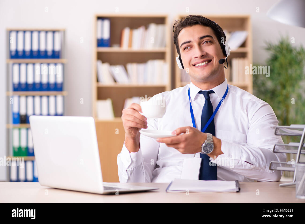 Handsome customer service clerk with headset Stock Photo - Alamy