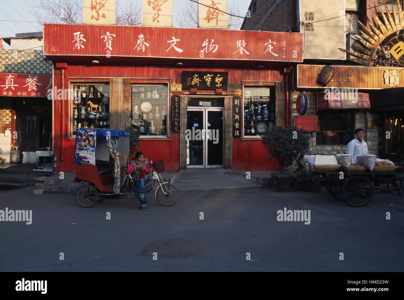 Rickshaws street vendor in front store hi-res stock photography and ...