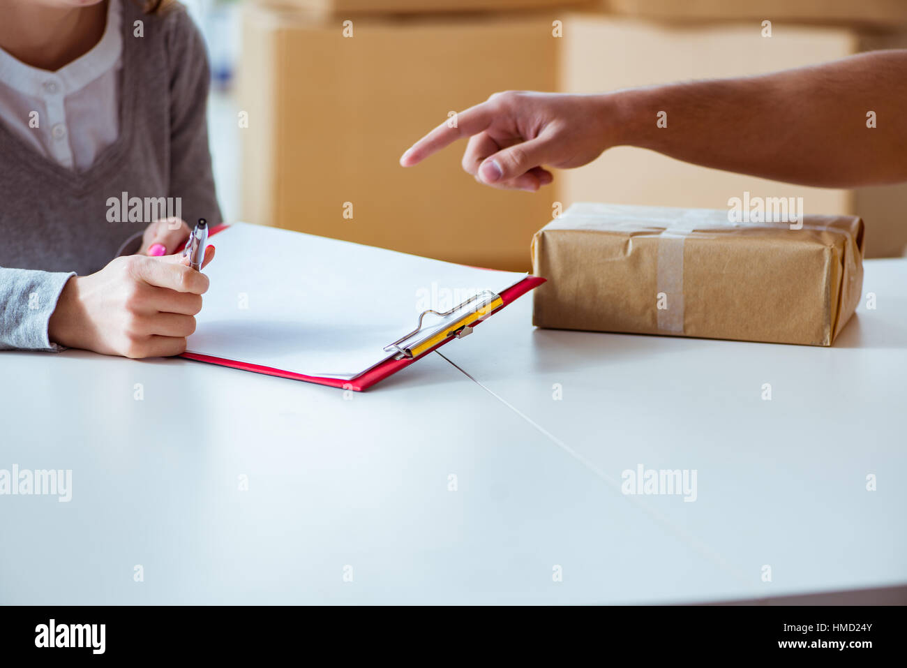 Delivery man delivering parcel box Stock Photo - Alamy