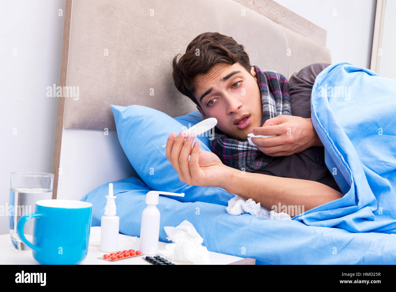 Sick man with flu lying in the bed Stock Photo - Alamy