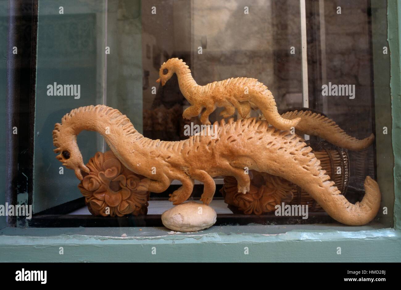 Dragon-shaped bread sculpture in front of a window, Rethymno, Crete ...