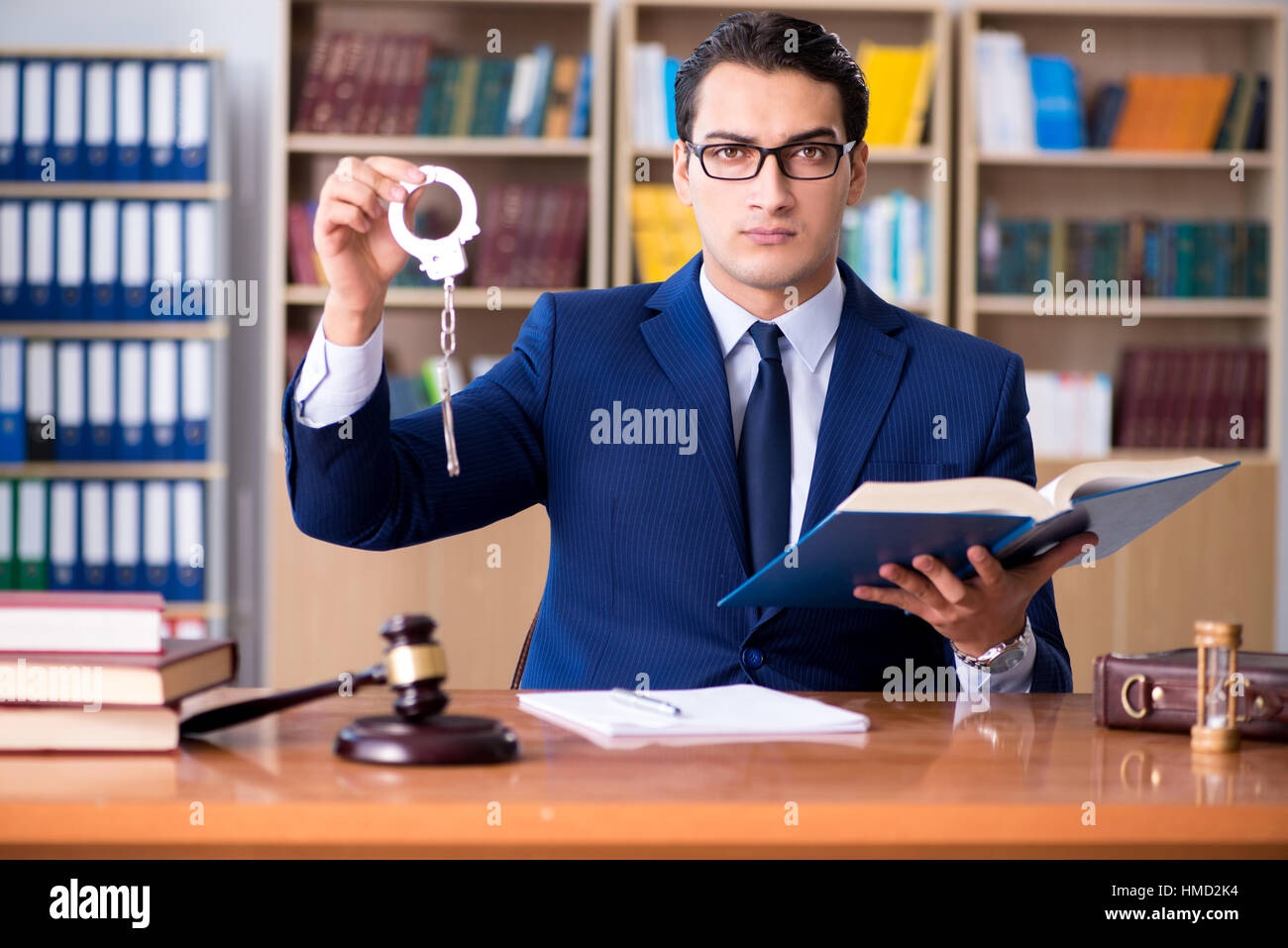 Handsome judge with gavel sitting in courtroom Stock Photo - Alamy
