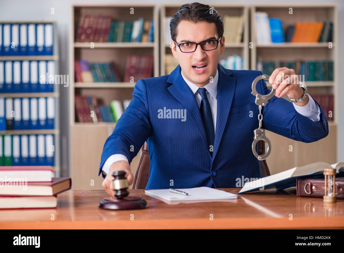 Handsome judge with gavel sitting in courtroom Stock Photo - Alamy