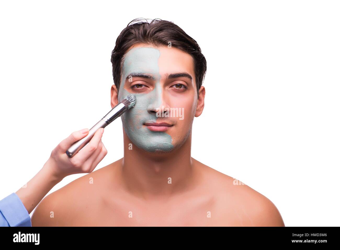 Man with face mask being applied on white Stock Photo - Alamy