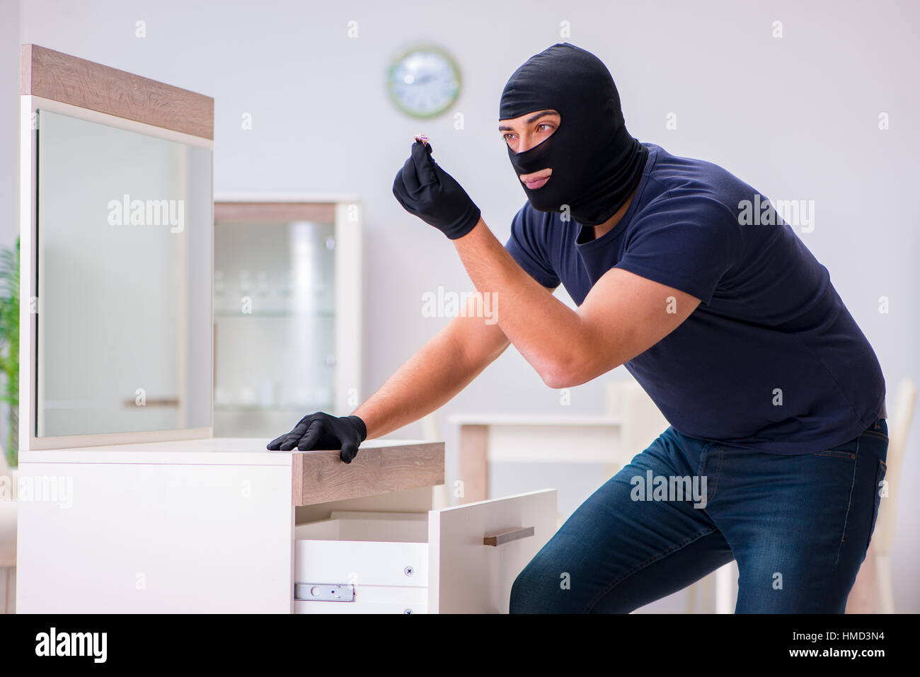 Robber wearing balaclava stealing valuable things Stock Photo - Alamy