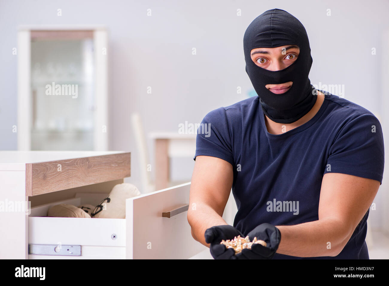 Robber wearing balaclava stealing valuable things Stock Photo - Alamy
