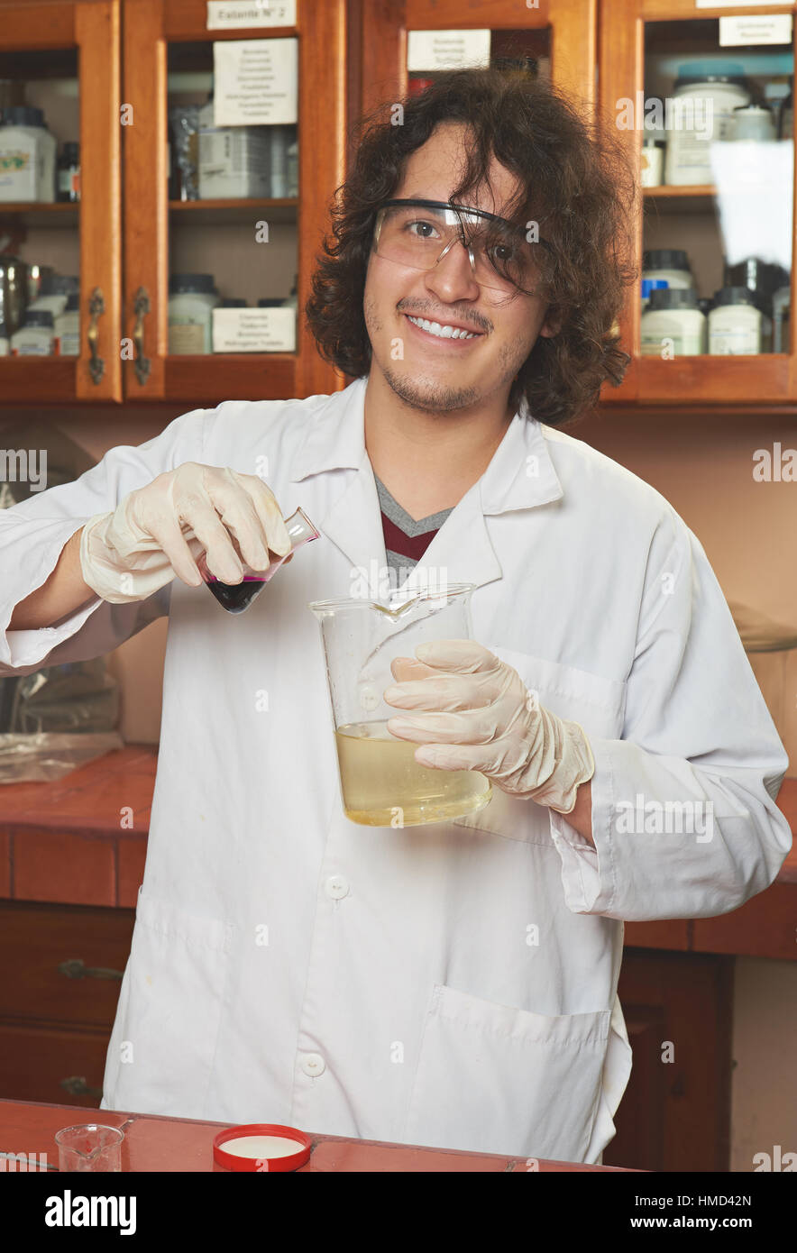young chemist mixing colour reagent in lab Stock Photo - Alamy