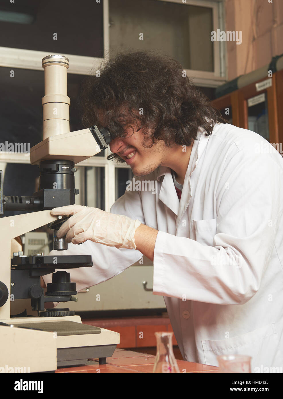 Young scientist looking through microscope hi-res stock photography and ...