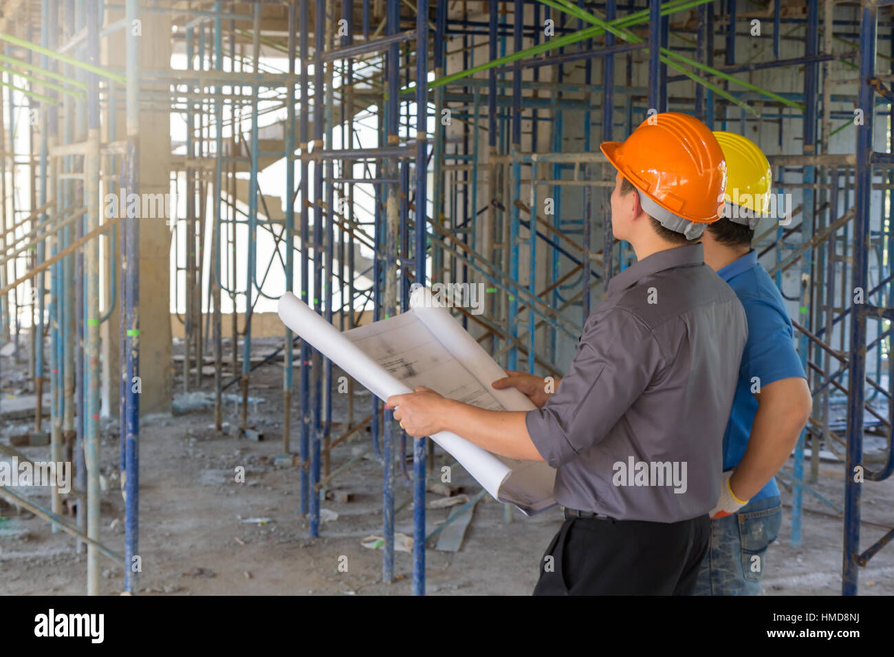 Construction concepts, Engineer and Architect working at Construction Site with blueprint Stock ...