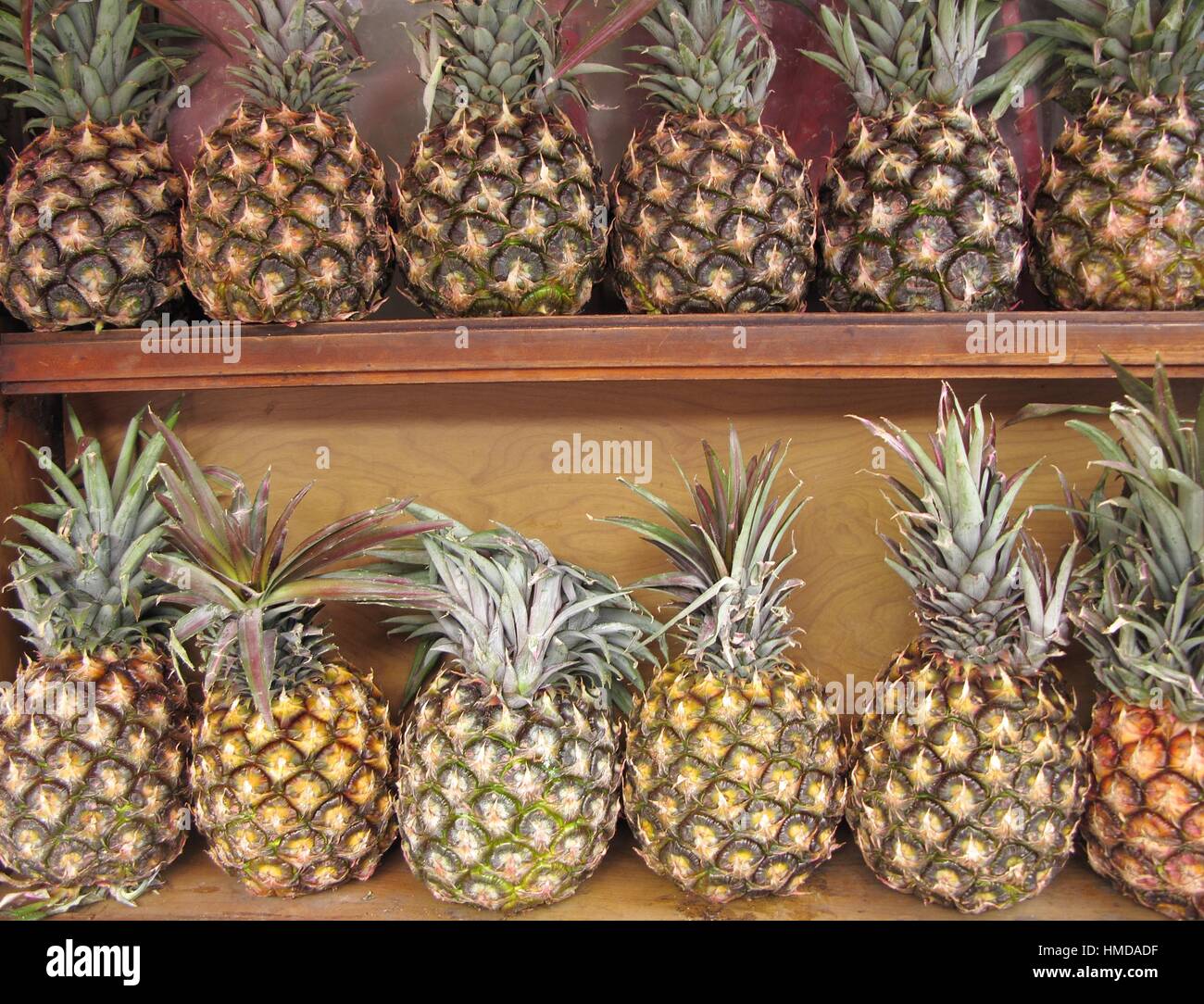 Pineapples display in a tropical fruit market Stock Photo - Alamy