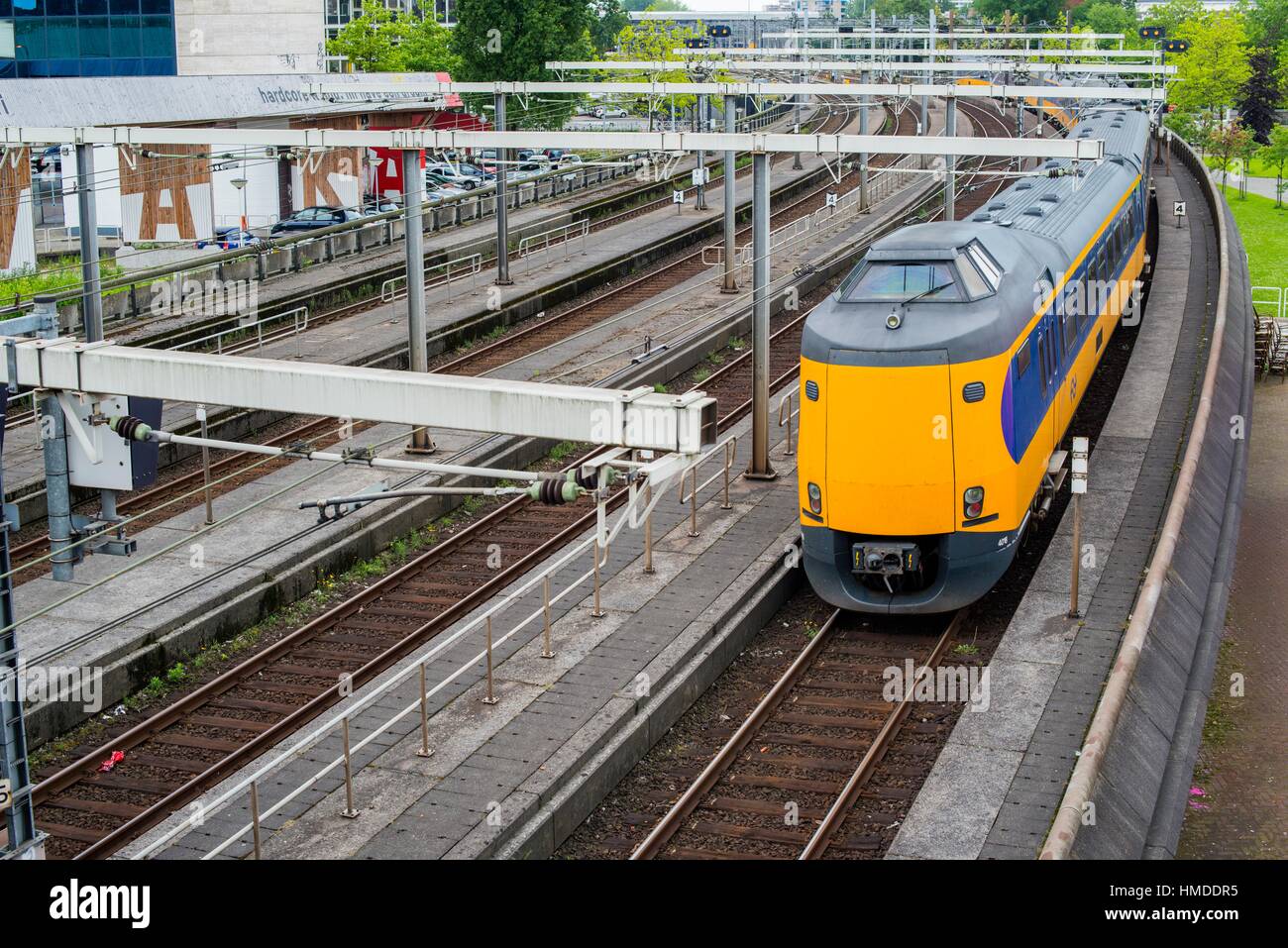 Rotterdam, Netherlands. Yellow and blue colored Dutch Intercity train ...