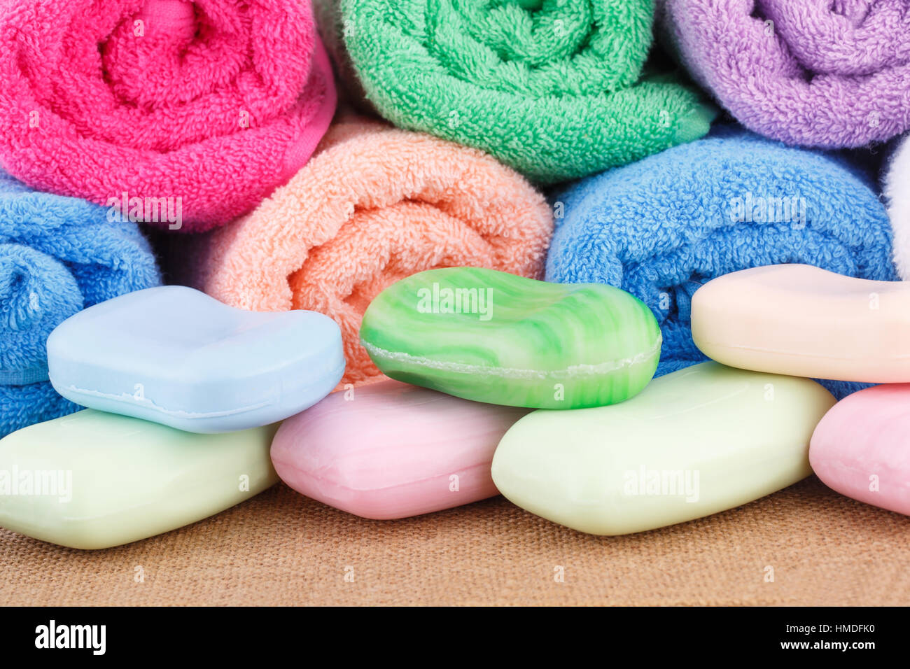 Colorful rolled towels with soaps closeup picture Stock Photo - Alamy