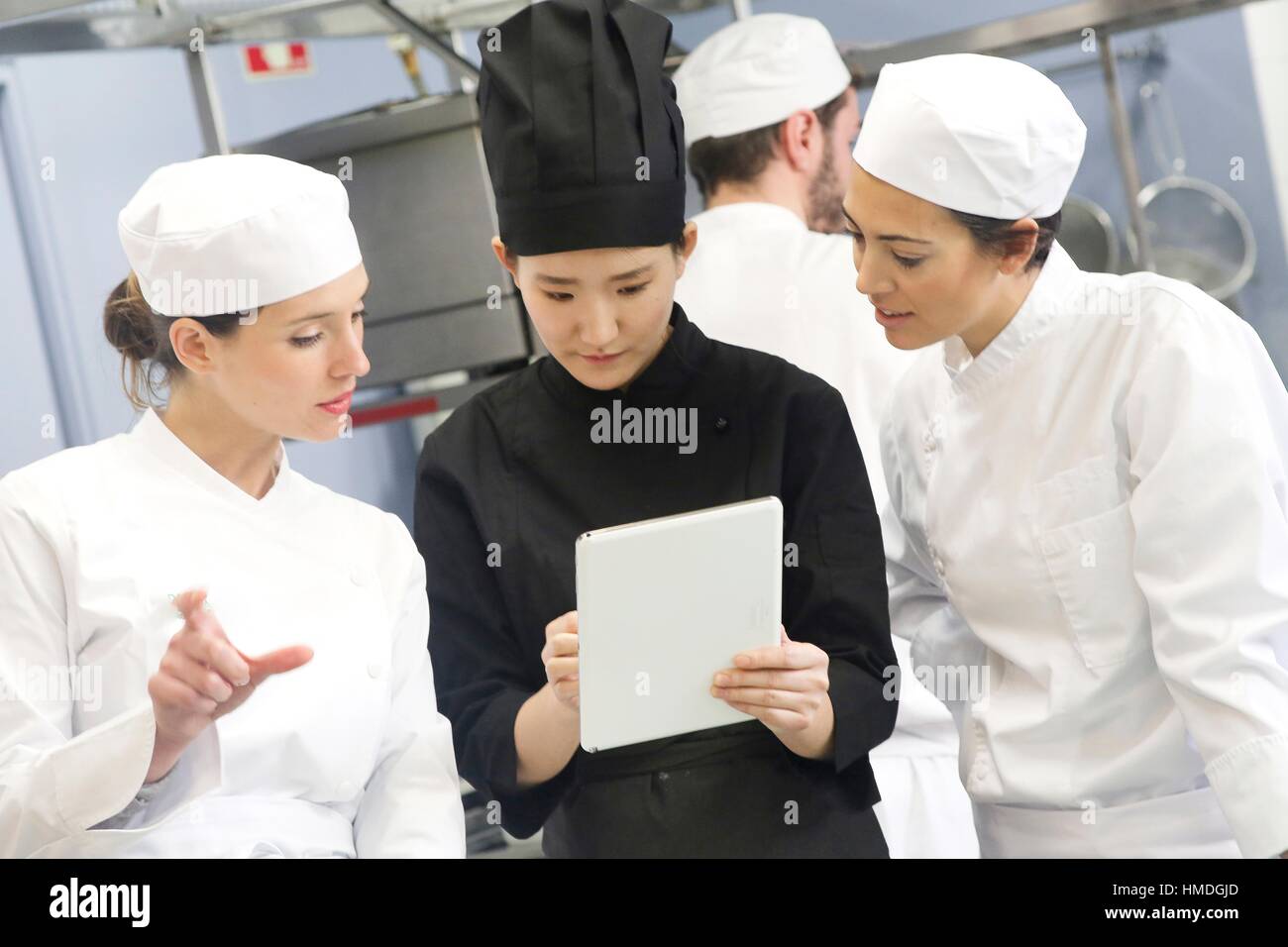 Chefs preparing menu in restaurant kitchen Stock Photo - Alamy
