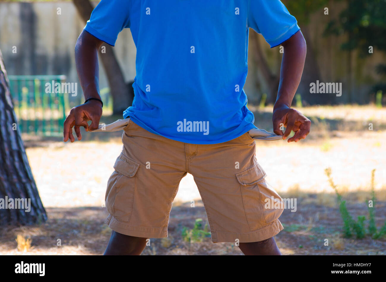Poverty in the empty pockets of a young black man Stock Photo - Alamy