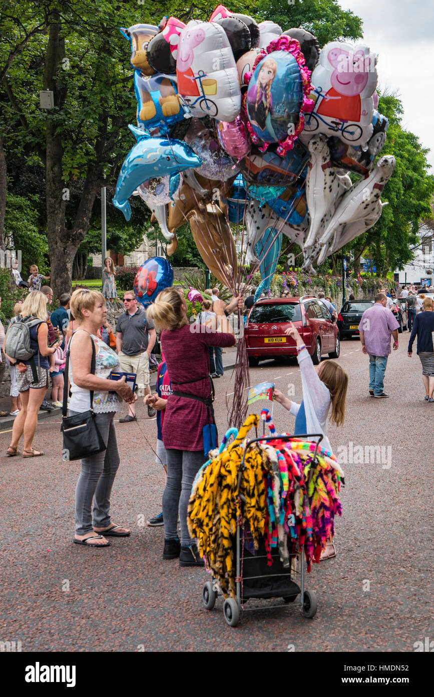 A little girl chooses her balloon ready for the Prestatyn Carnival ...