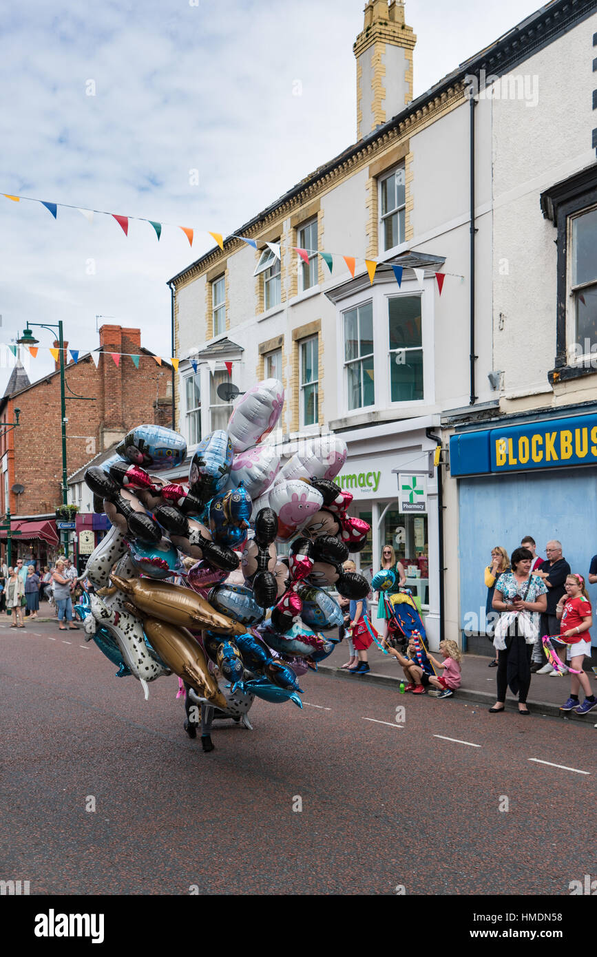 A ballon seller tempts spectators at the Prestatyn Carnival Parade ...