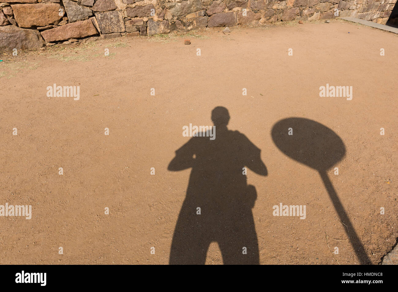 Shadow of a man taking a selfie standing next to a lamp post in ...