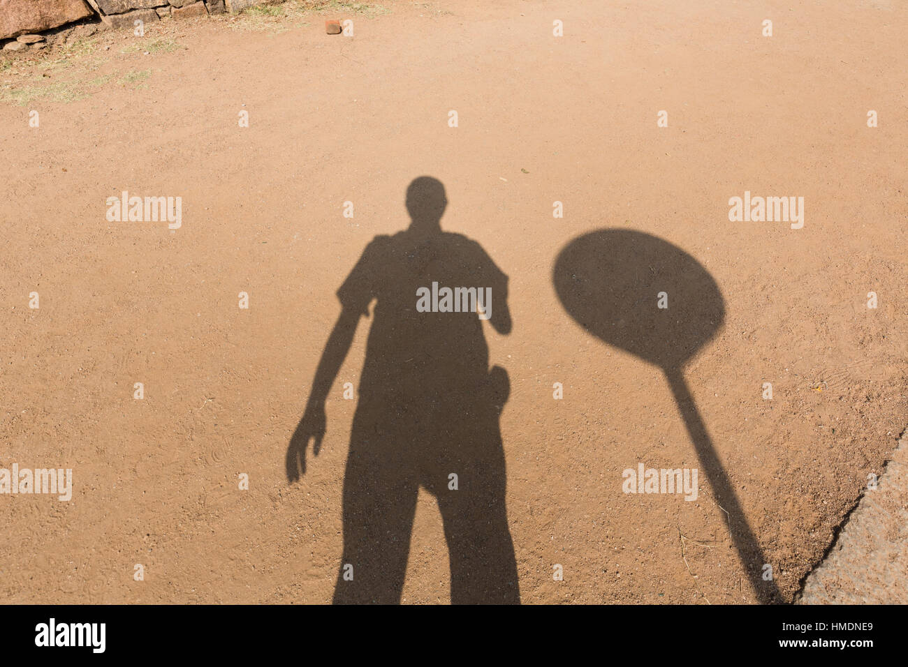 Shadow of a man taking a selfie standing next to a lamp post in ...