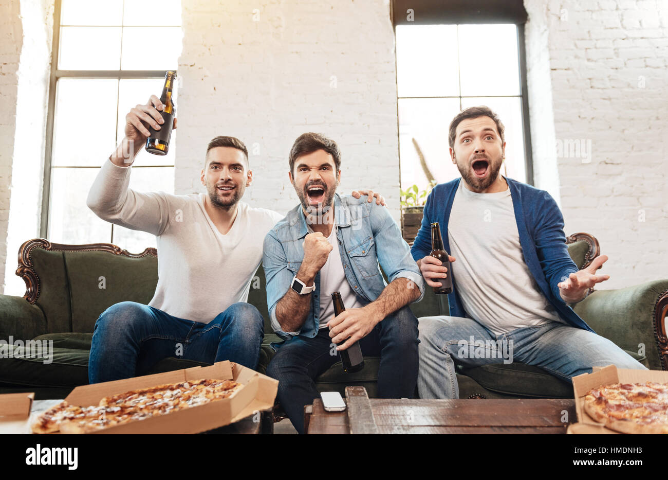 Happy jubilant men celebrating the victory Stock Photo - Alamy