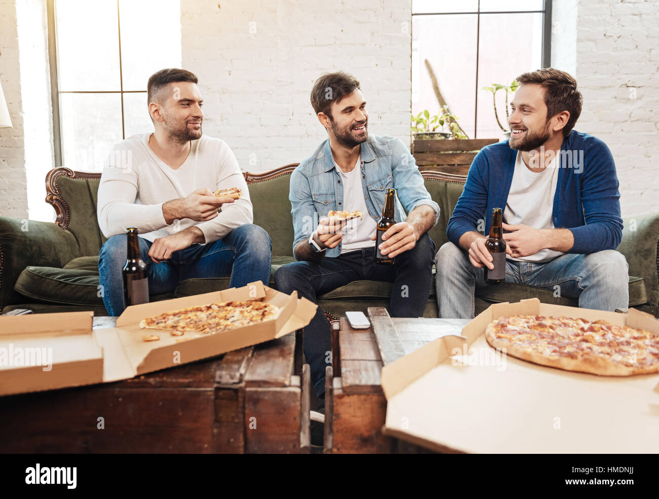 Good looking joyful friends talking to each other Stock Photo - Alamy