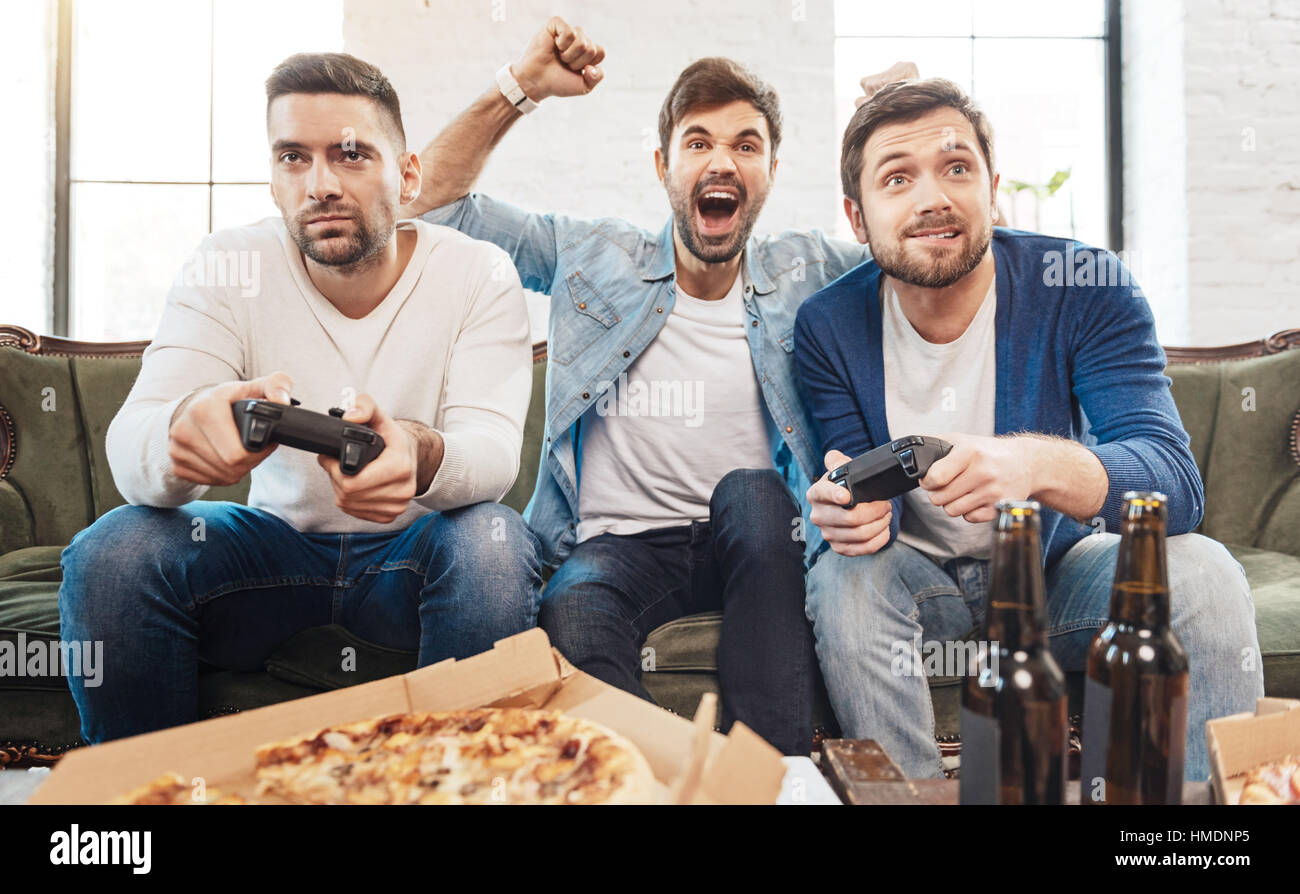 Nice good looking men playing video games Stock Photo - Alamy