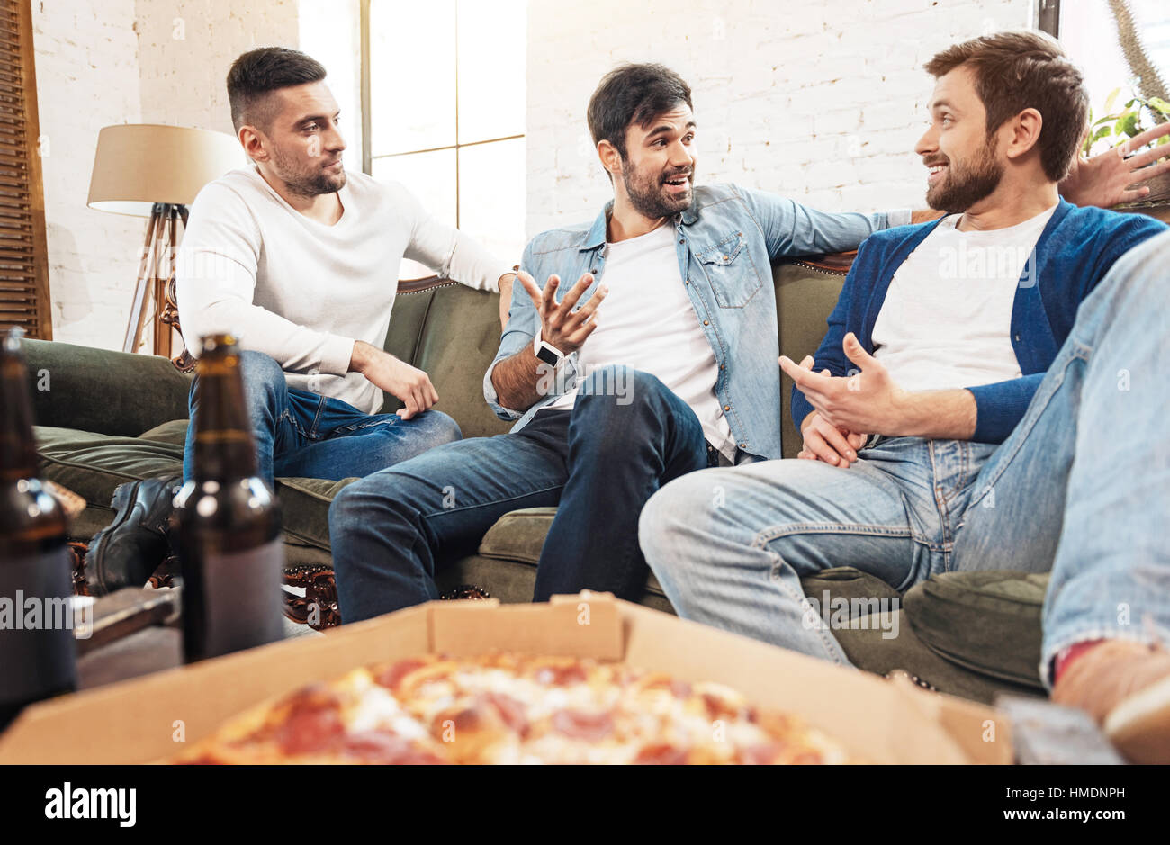 Delighted handsome friends speaking to each other Stock Photo - Alamy