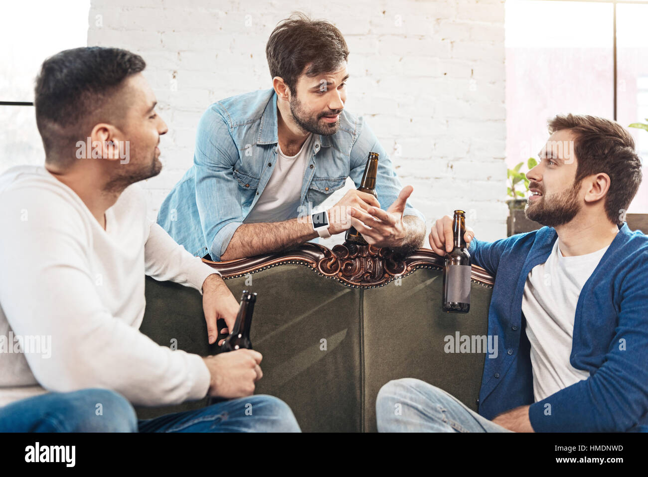 Good looking joyful friends having a conversation Stock Photo - Alamy