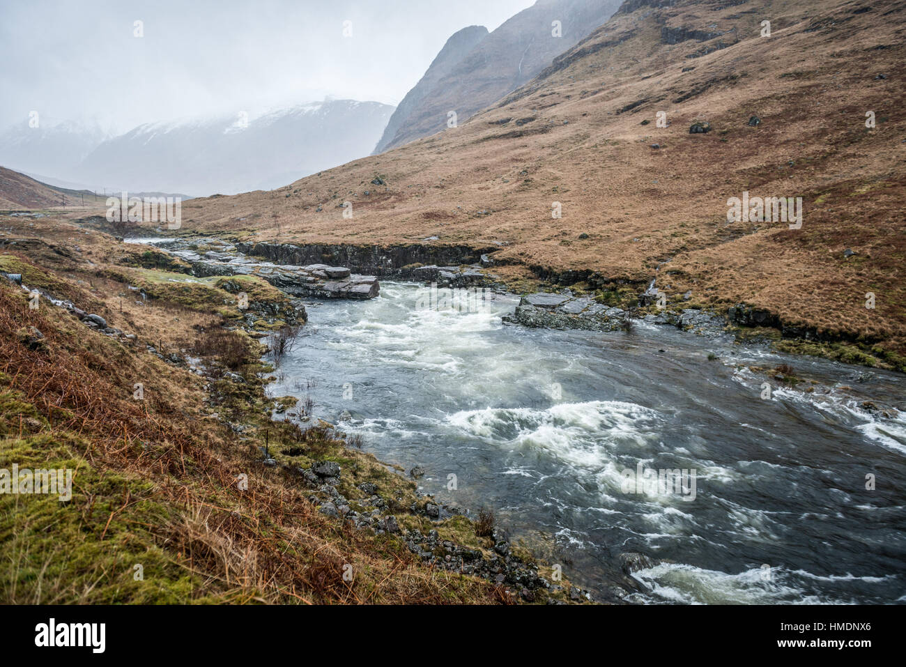 A river in full spate flows down the hill side in Glen Etiv, in the ...
