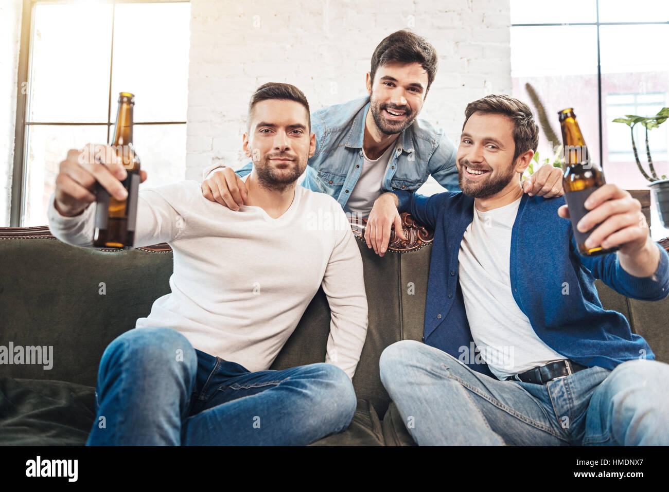 Delighted positive men cheering for you Stock Photo - Alamy