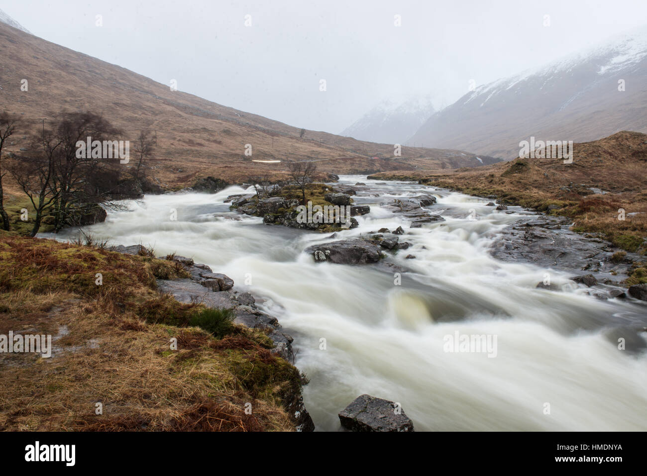 A river in full spate flows down the hill side in Glen Etiv, in the ...