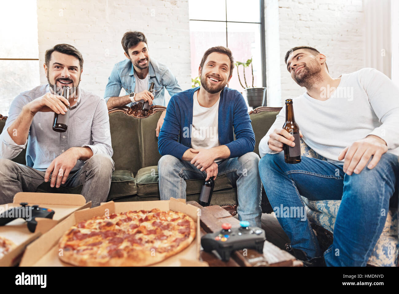 Cheerful positive men resting at home Stock Photo - Alamy