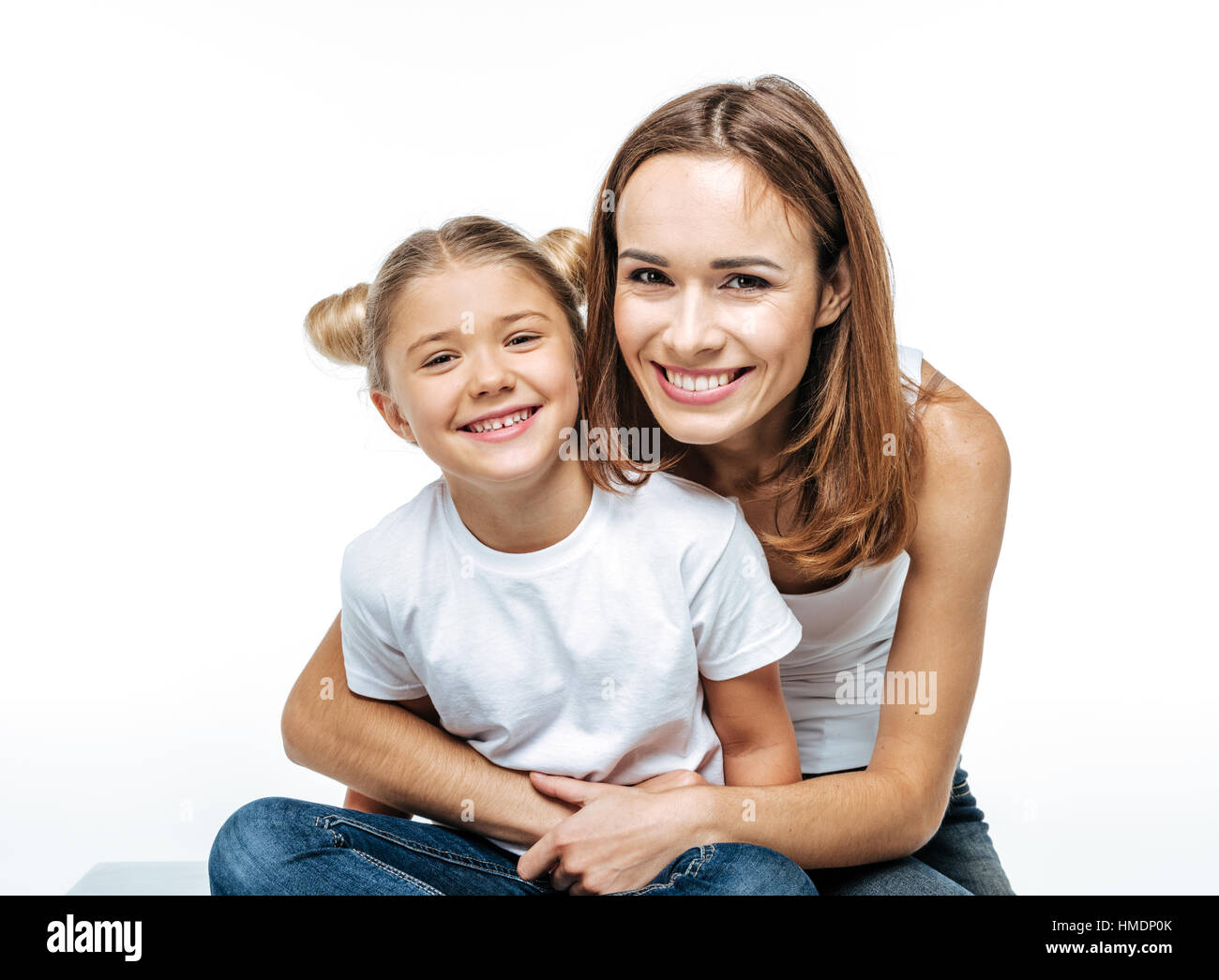 Smiling mother hugging daughter Stock Photo - Alamy