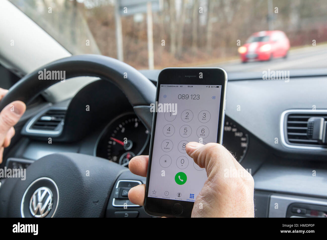 A car driver is using a mobile phone, smartphone, while driving the car ...