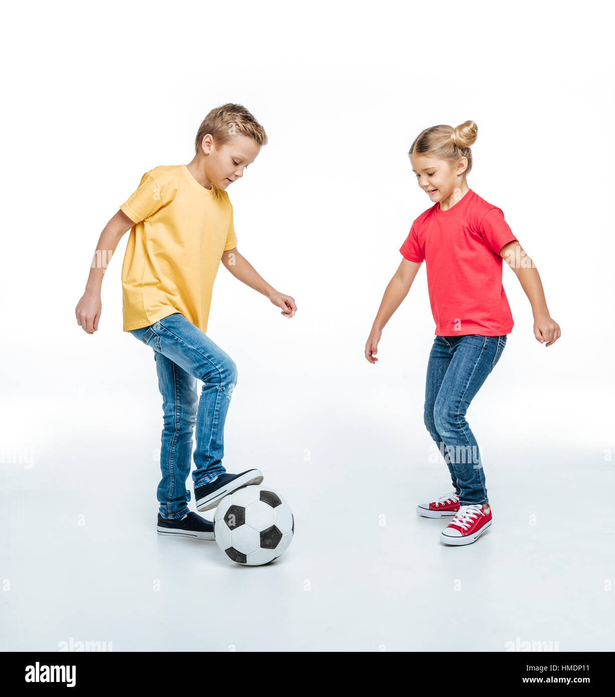 siblings playing with soccer ball Stock Photo - Alamy