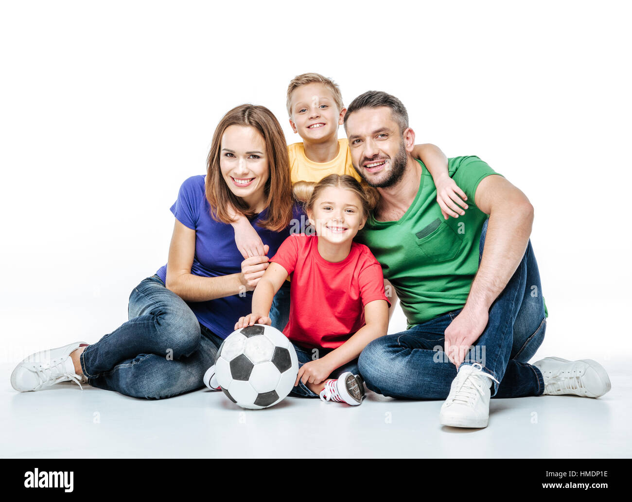 Happy family with soccer ball Stock Photo - Alamy
