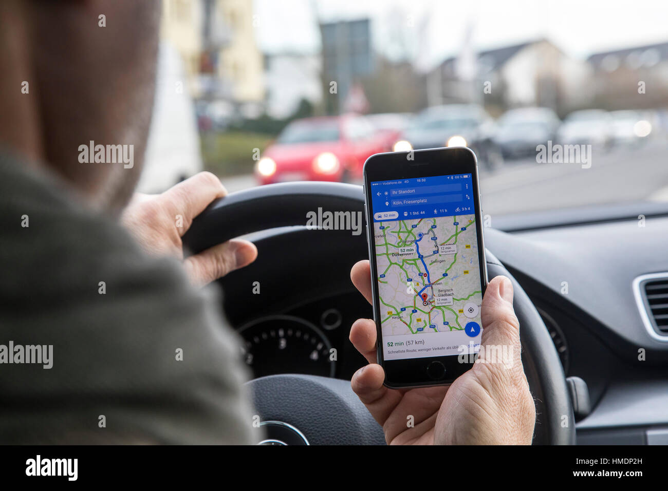 A car driver is using a mobile phone, smartphone, while driving the car ...