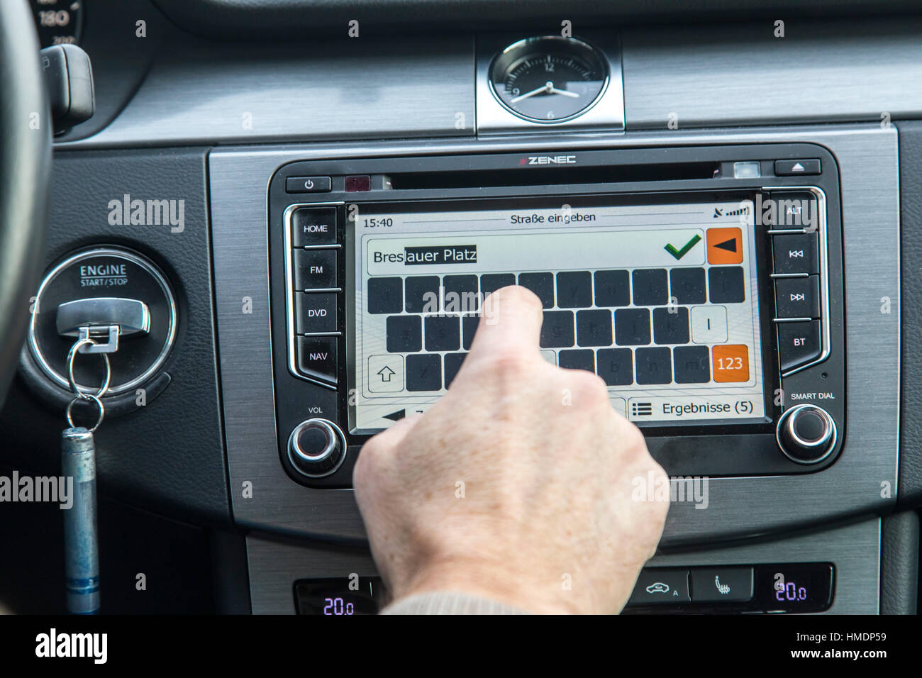 A car driver is using the cars navigation system, while driving the car ... A car driver is using the cars navigation system, while driving the car ...